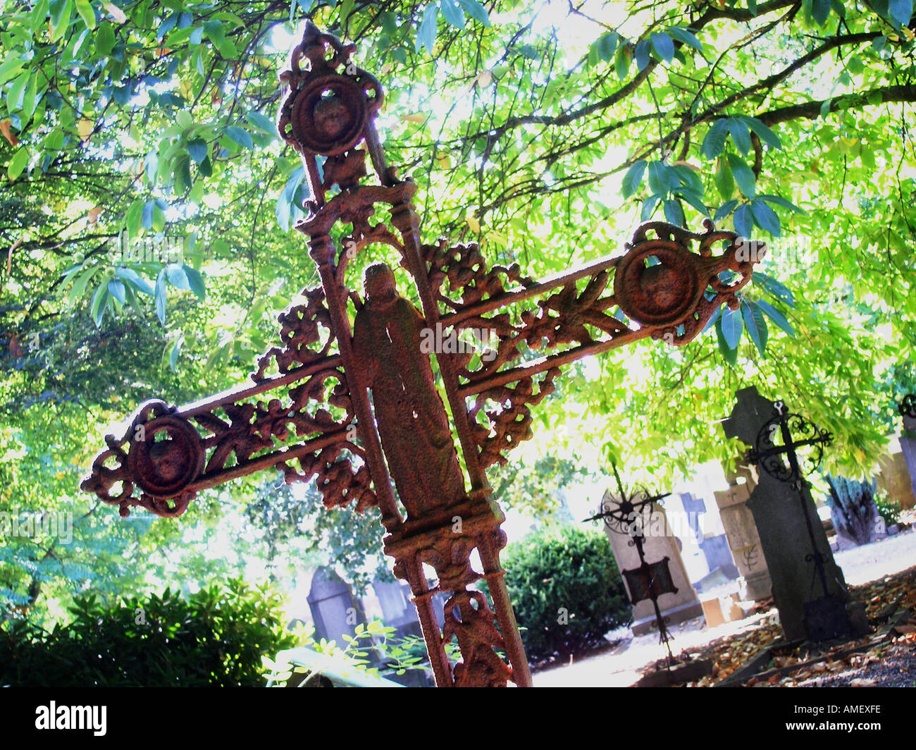 wrought iron grave yard cross in churchyard Stock Photo - Alamy