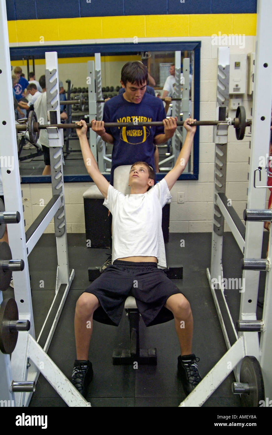 High school student work out lifting weights in a weight training class ...