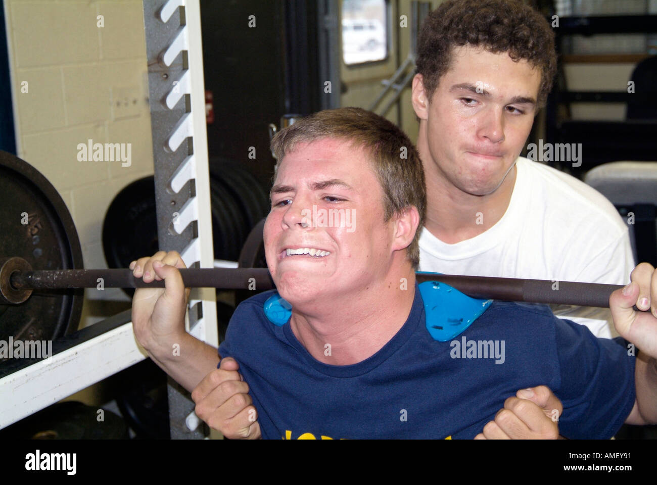 High school student work out lifting weights in a weight training class ...