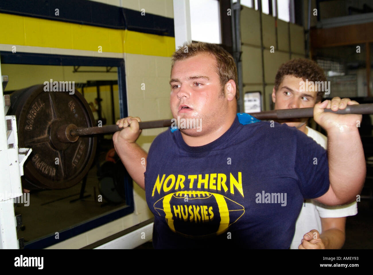 High school student work out lifting weights in a weight training class ...
