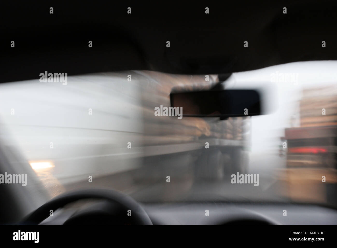View from the inside of a car driving along a road it a motion blur of ...