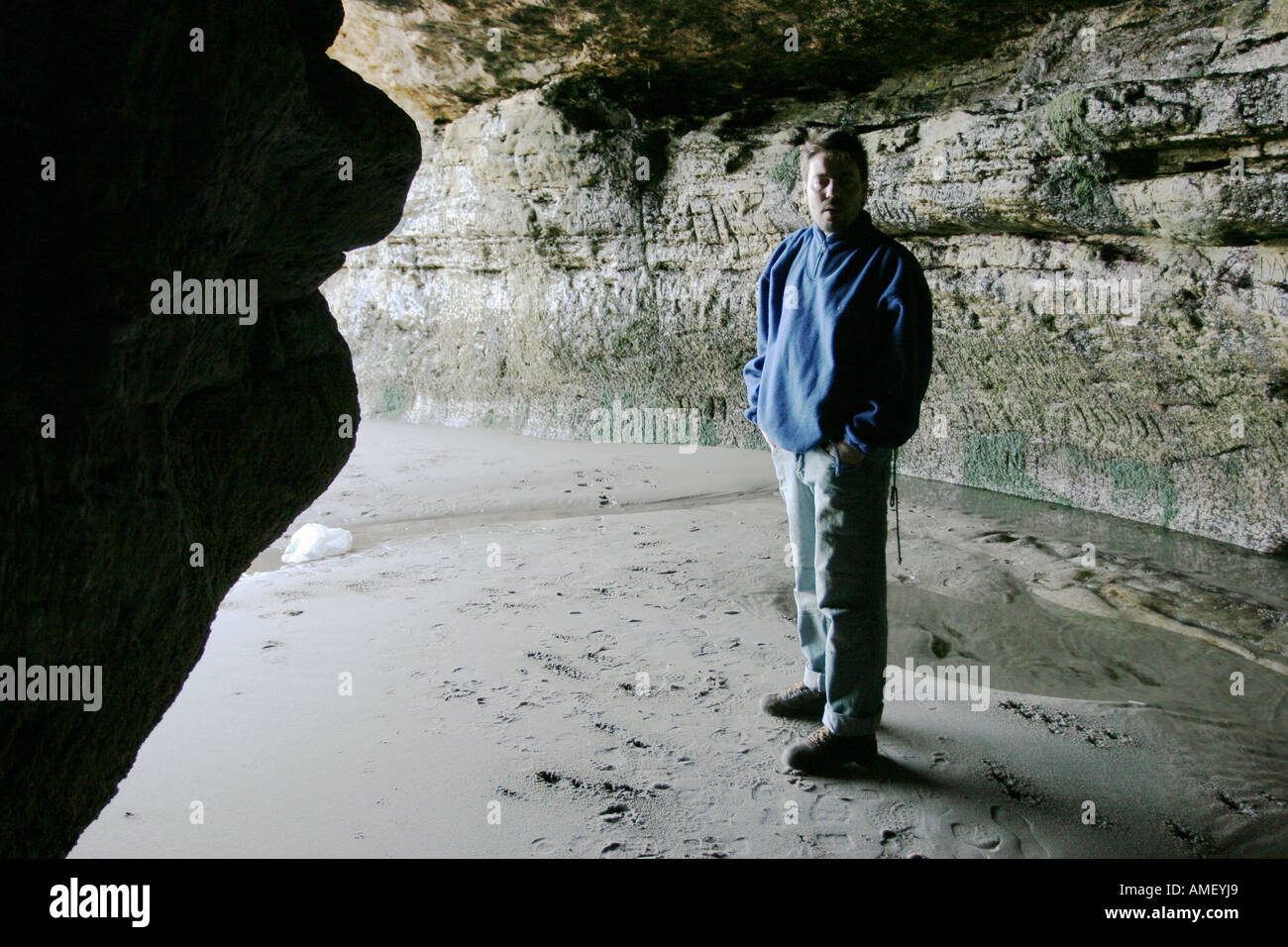 Man standing outside a cave High Resolution Stock Photography and ...