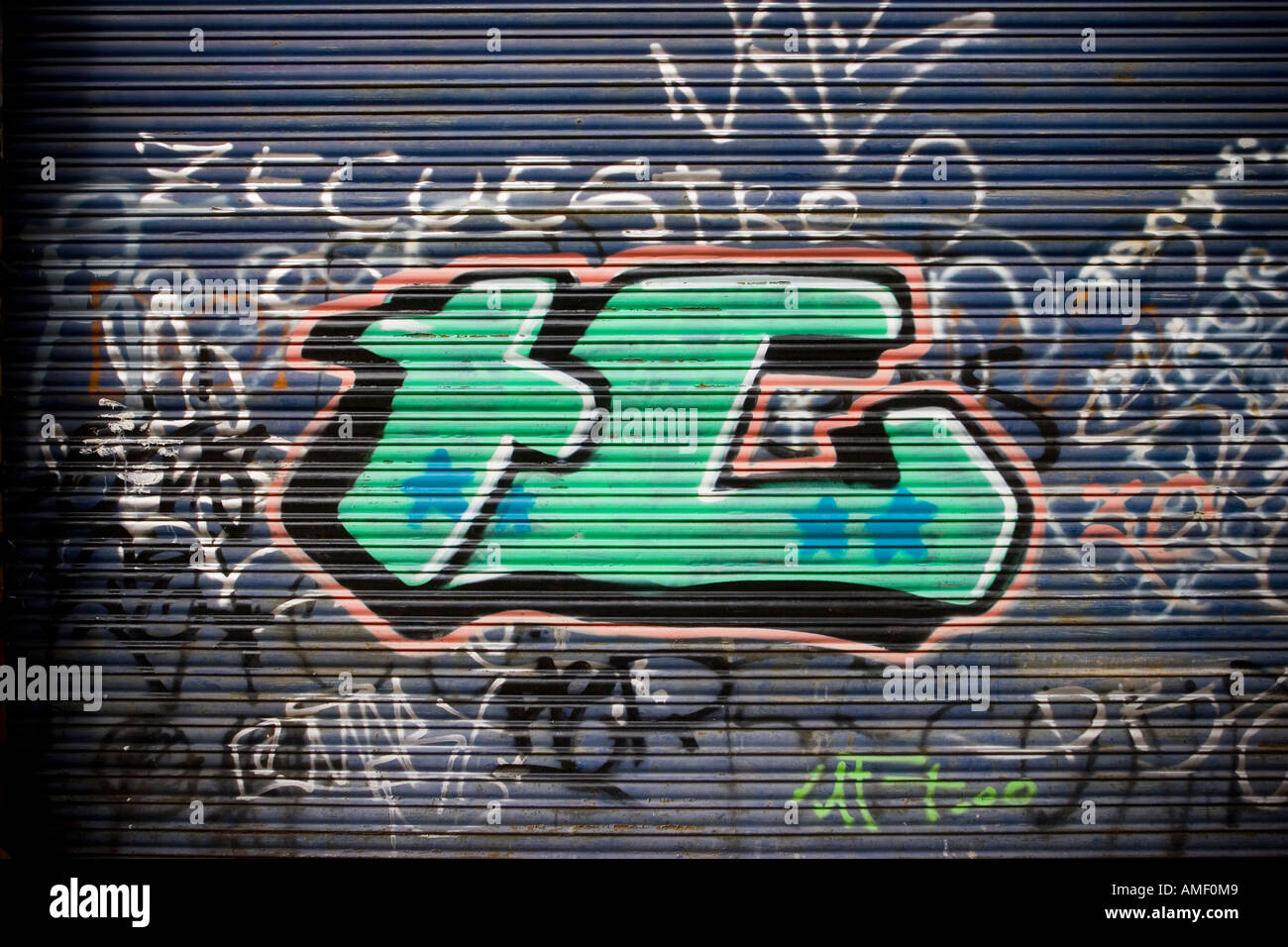 Urban graffiti painted on a garage gate of an abandoned factory in the ...