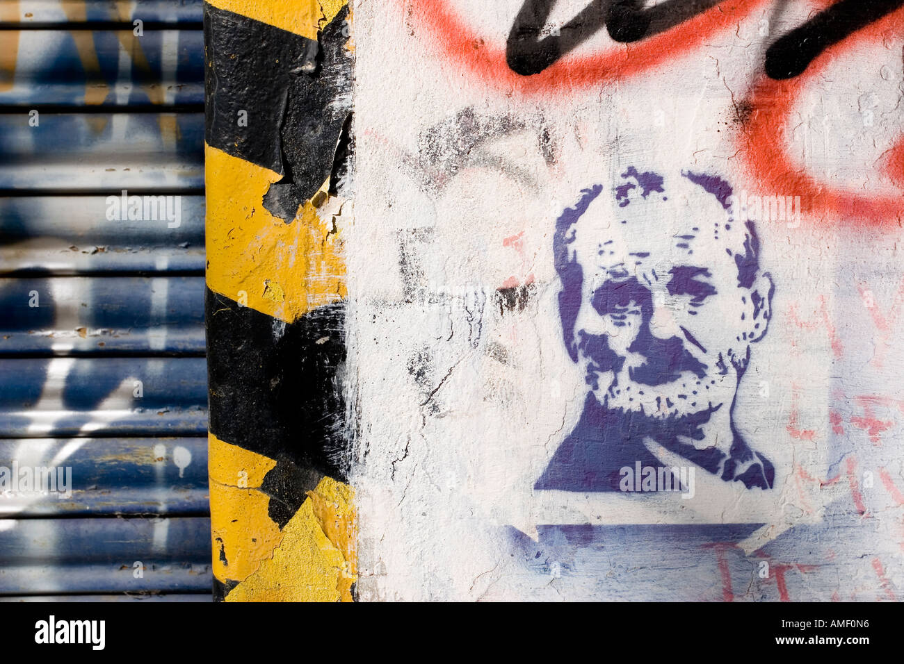 Urban graffiti of an old man painted on the wall of an abandoned ...