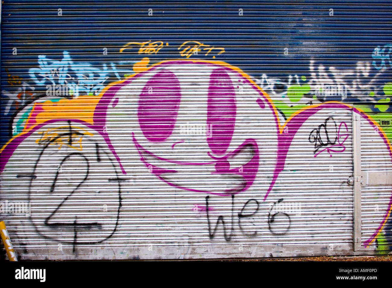 Urban graffiti painted on a garage gate of an abandoned factory in the ...