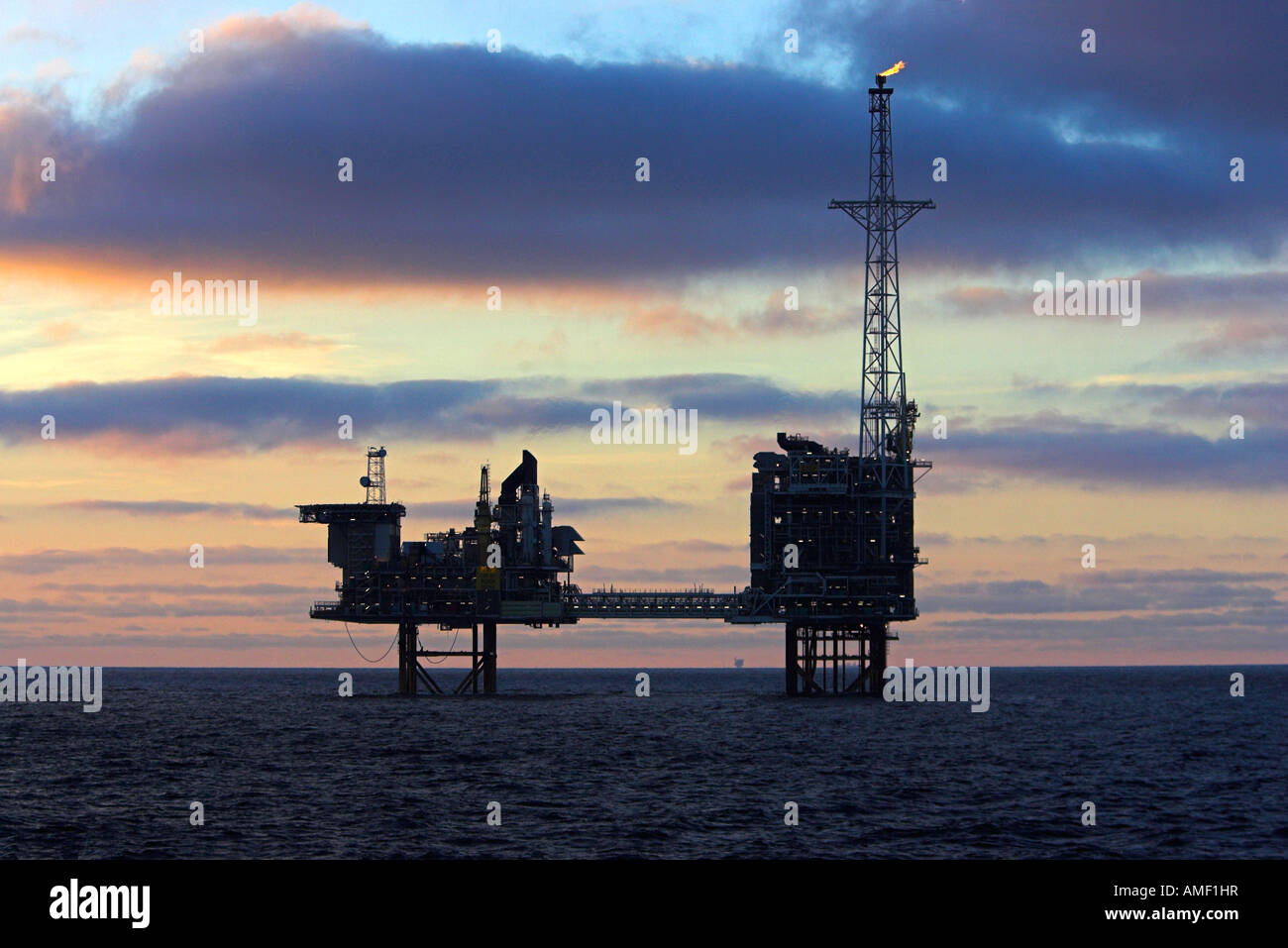 Rig complex at sunset Stock Photo - Alamy