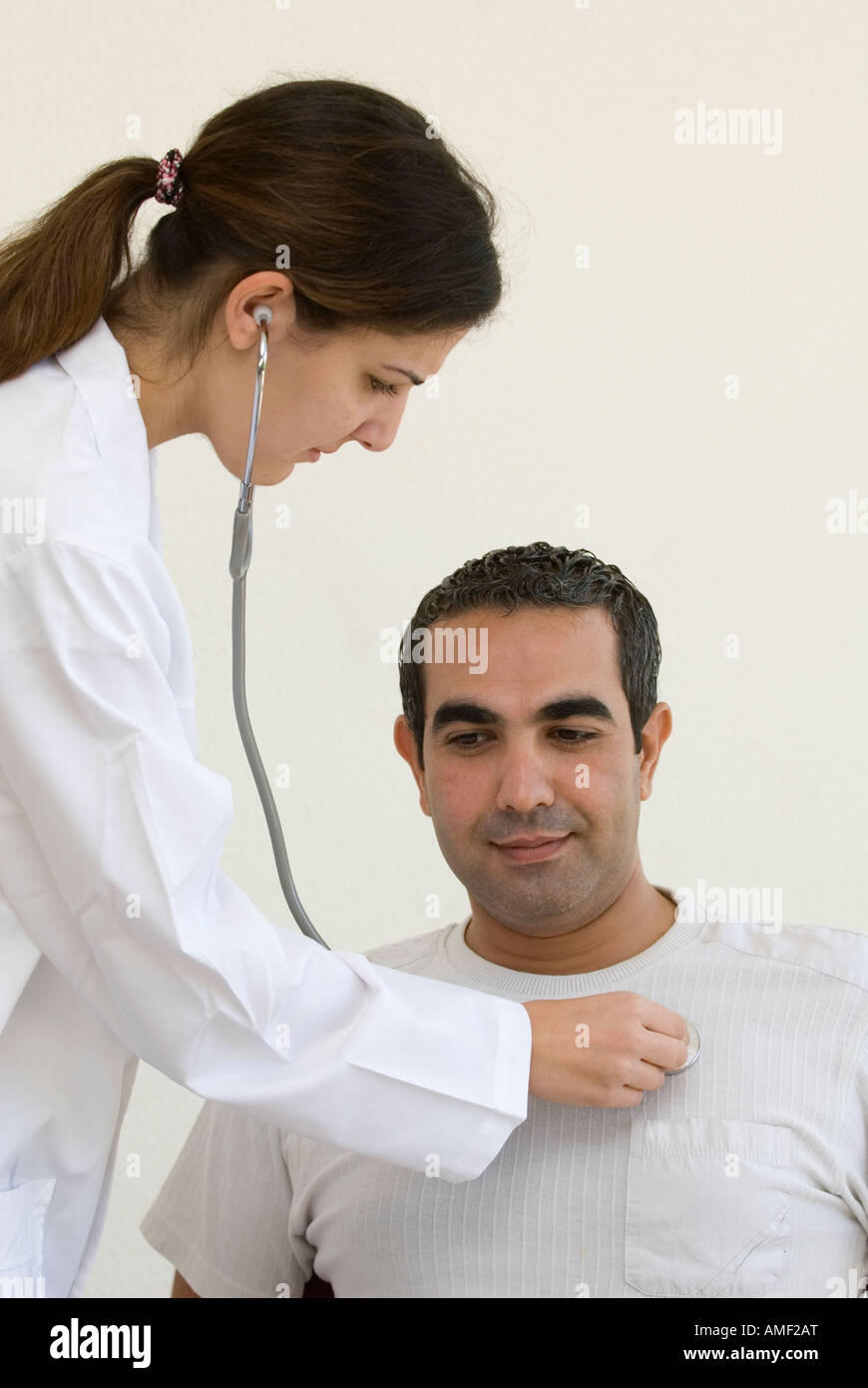 Female doctor examining male patient Stock Photo - Alamy