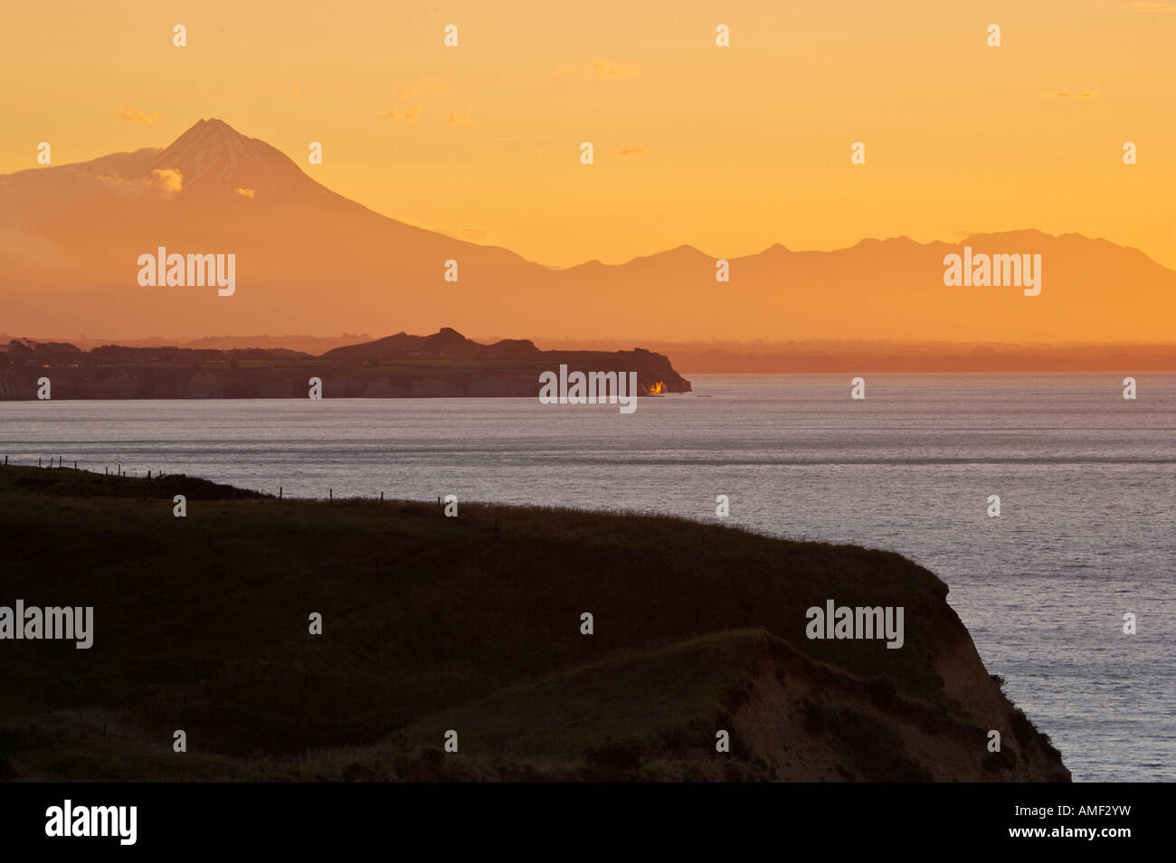 Mt Taranaki / Mt Egmont seen from Northern Taranaki Bight at sunset ...