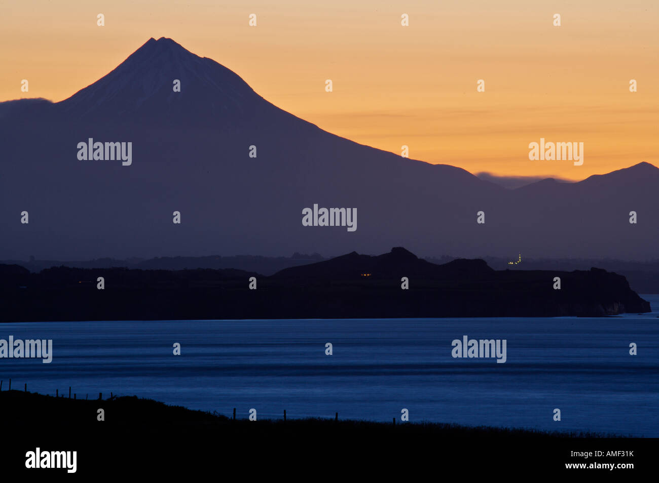 Mt Taranaki / Mt Egmont seen from Northern Taranaki Bight at sunset ...