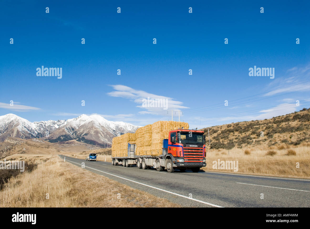 Truck carrying straw bales through the Canterbury high country, New ...