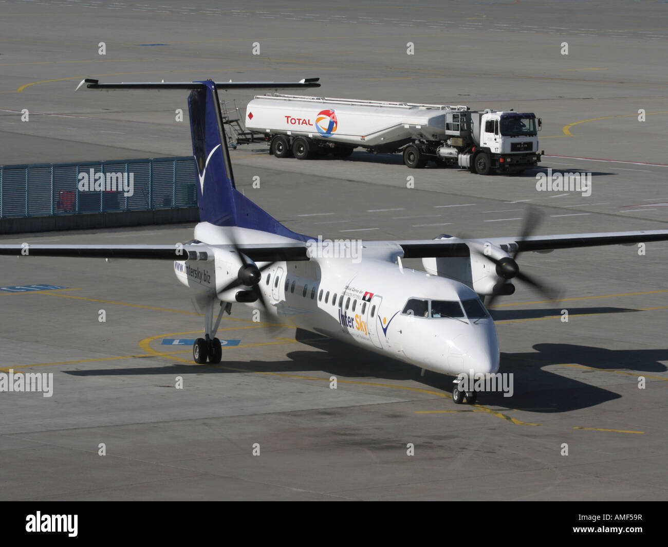 InterSky Bombardier Dash 8-Q300 on the ramp with fuel bowser Stock ...