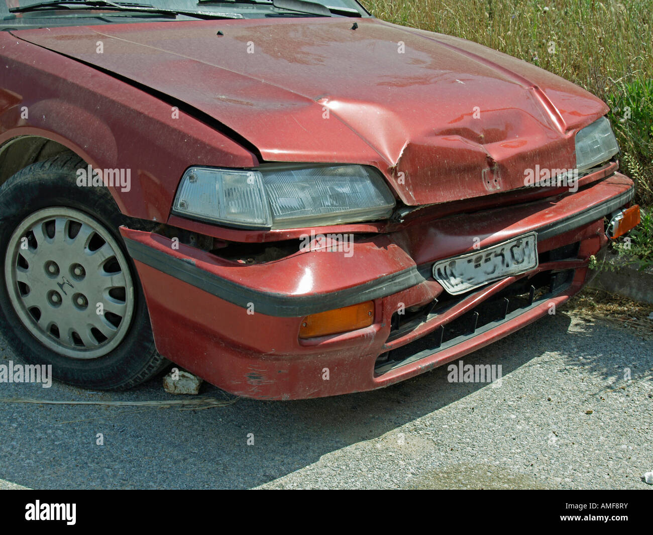 damaged car standing at road side after an accident broken engine ...