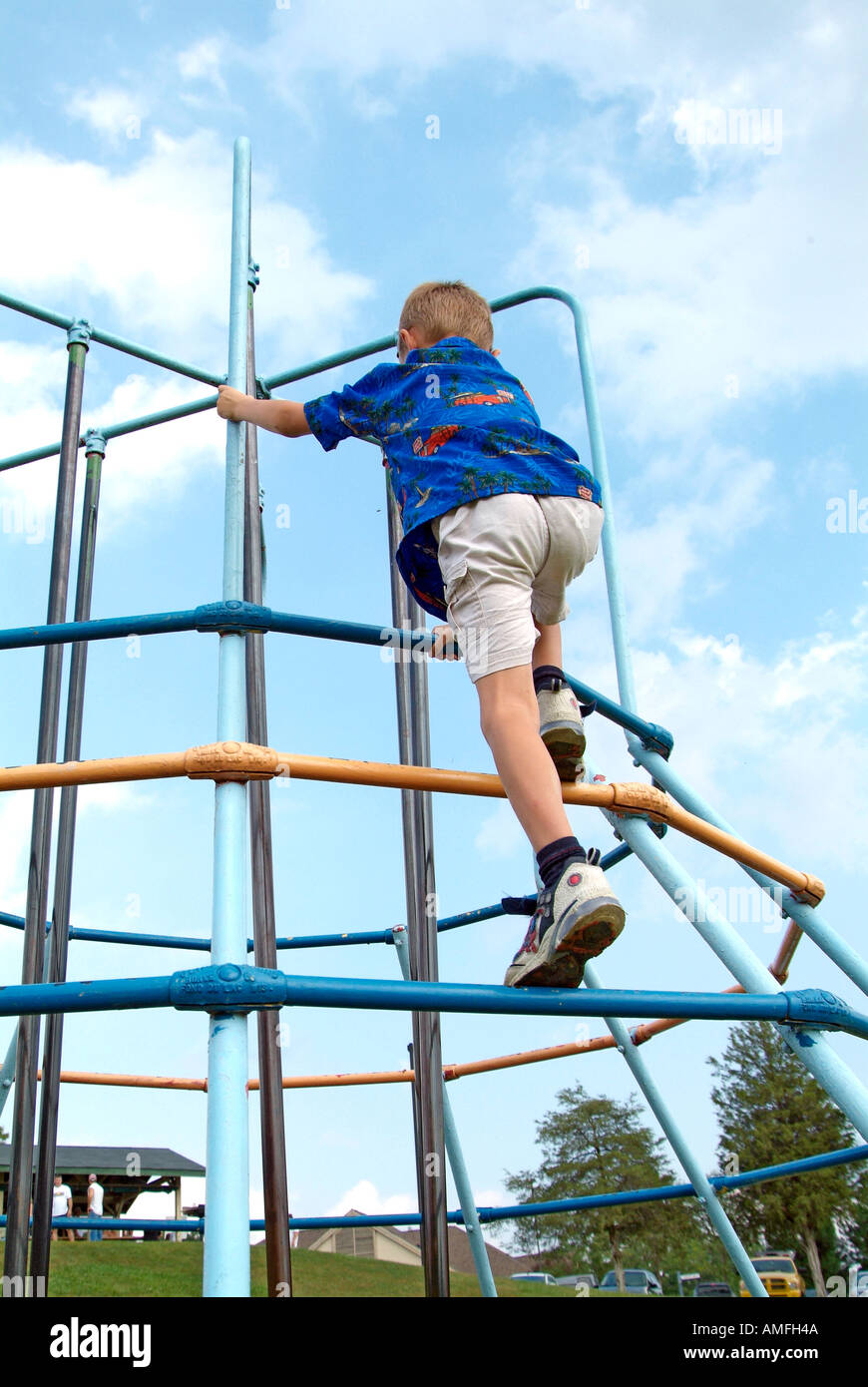 Young boys and girls climb on bars to help develop coordination during ...