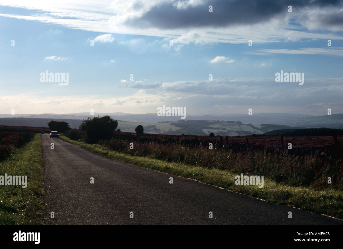 Open country road with car Stock Photo - Alamy
