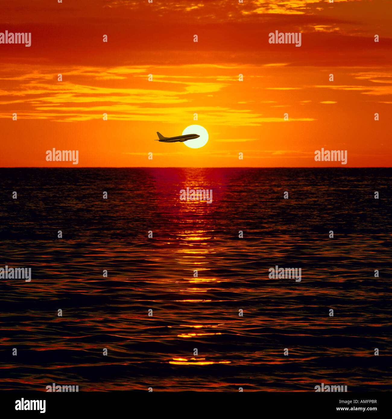 sunset above sea with flying airplane Stock Photo - Alamy