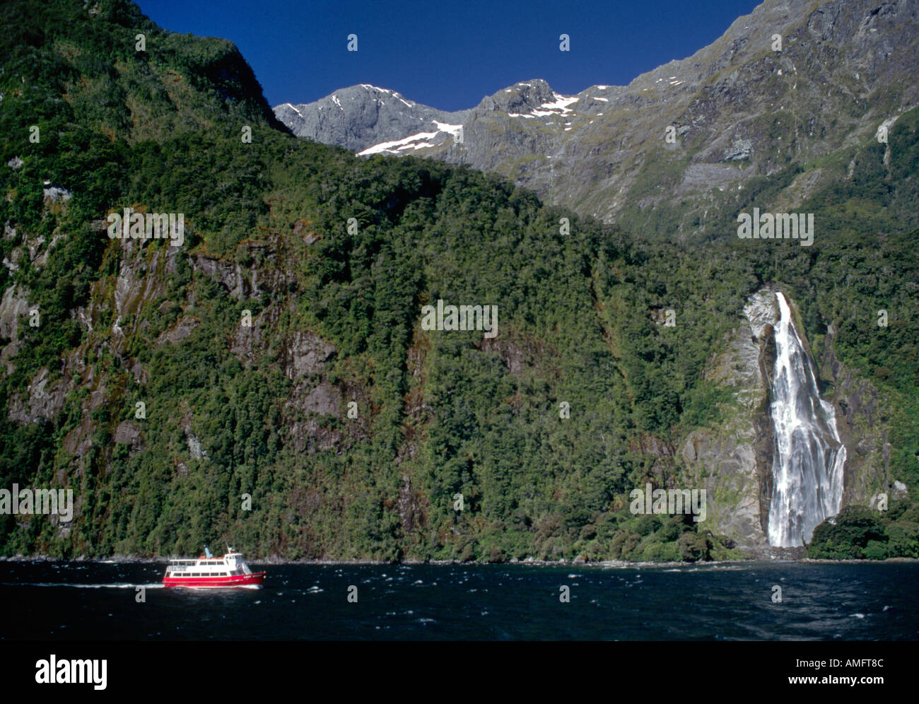 Tour boat on MILFORD SOUND below BOWEN FALLS 162 meter drop FIORDLAND ...