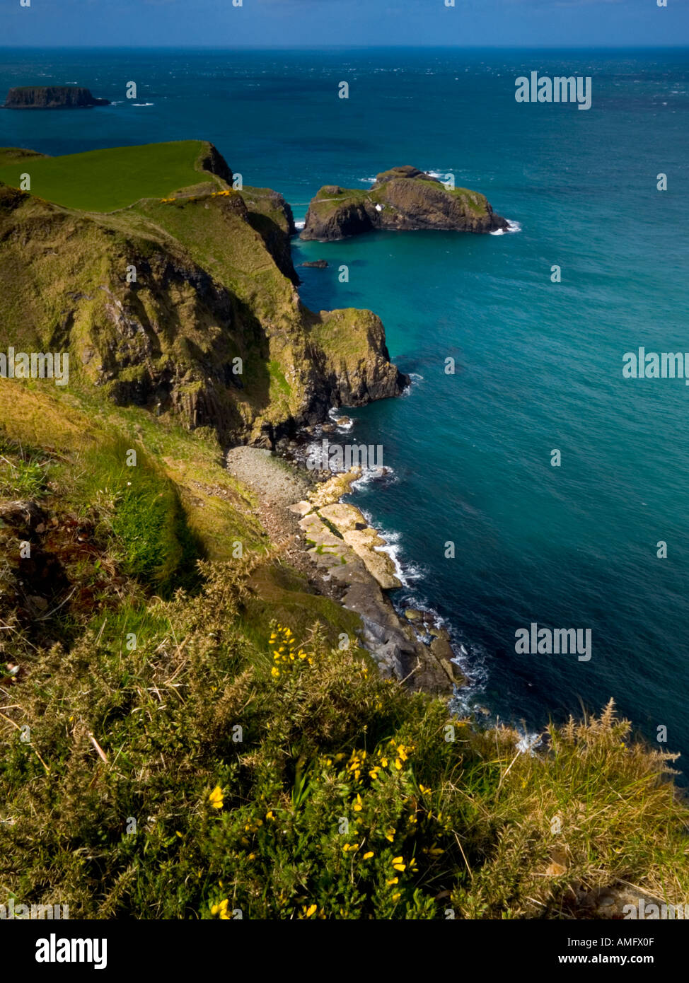 gorgeous blue waters nestle below the Antrim cliffs Stock Photo - Alamy
