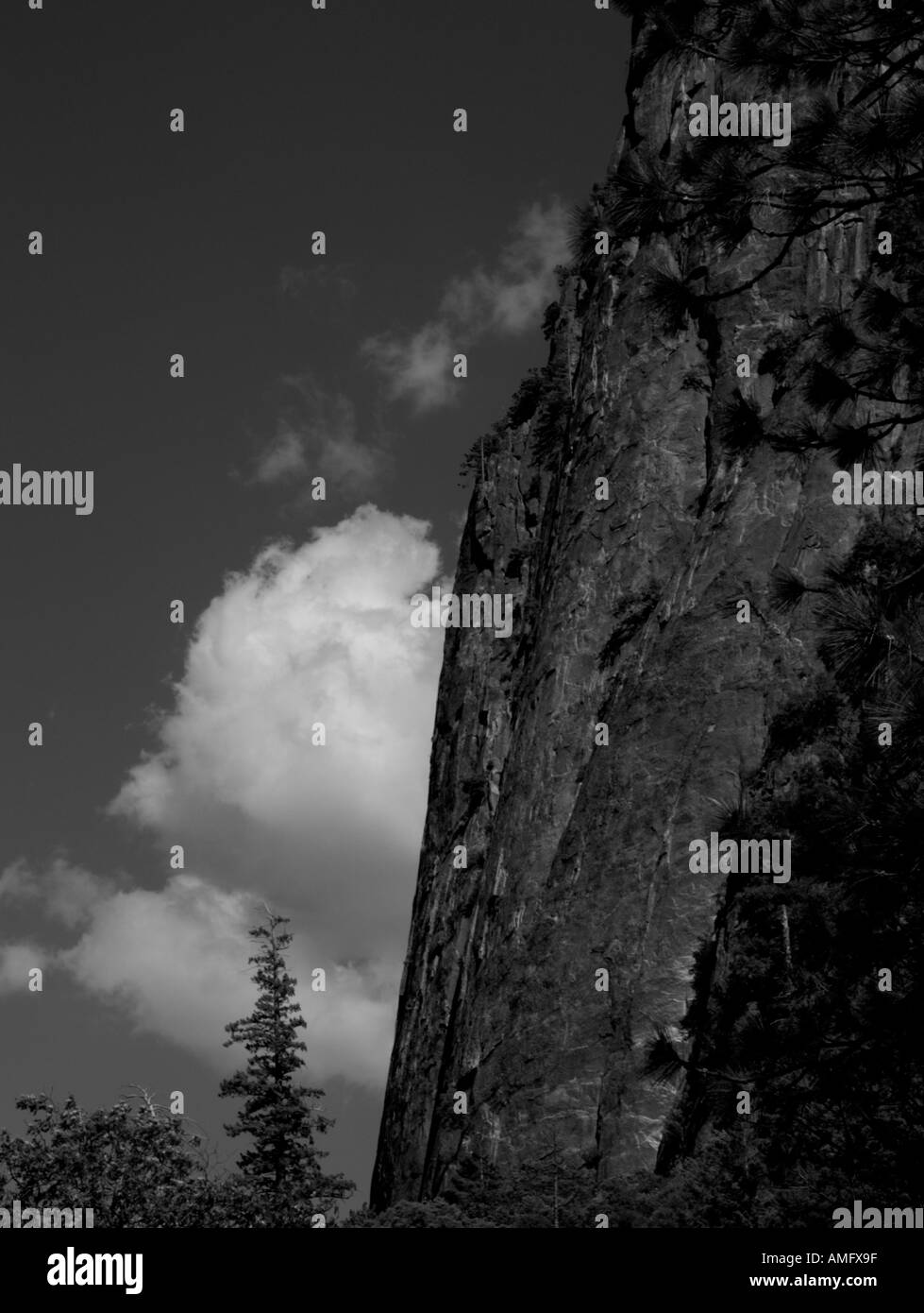 A cloud sneaks out from behind the colossal rock faces at Yosemite ...