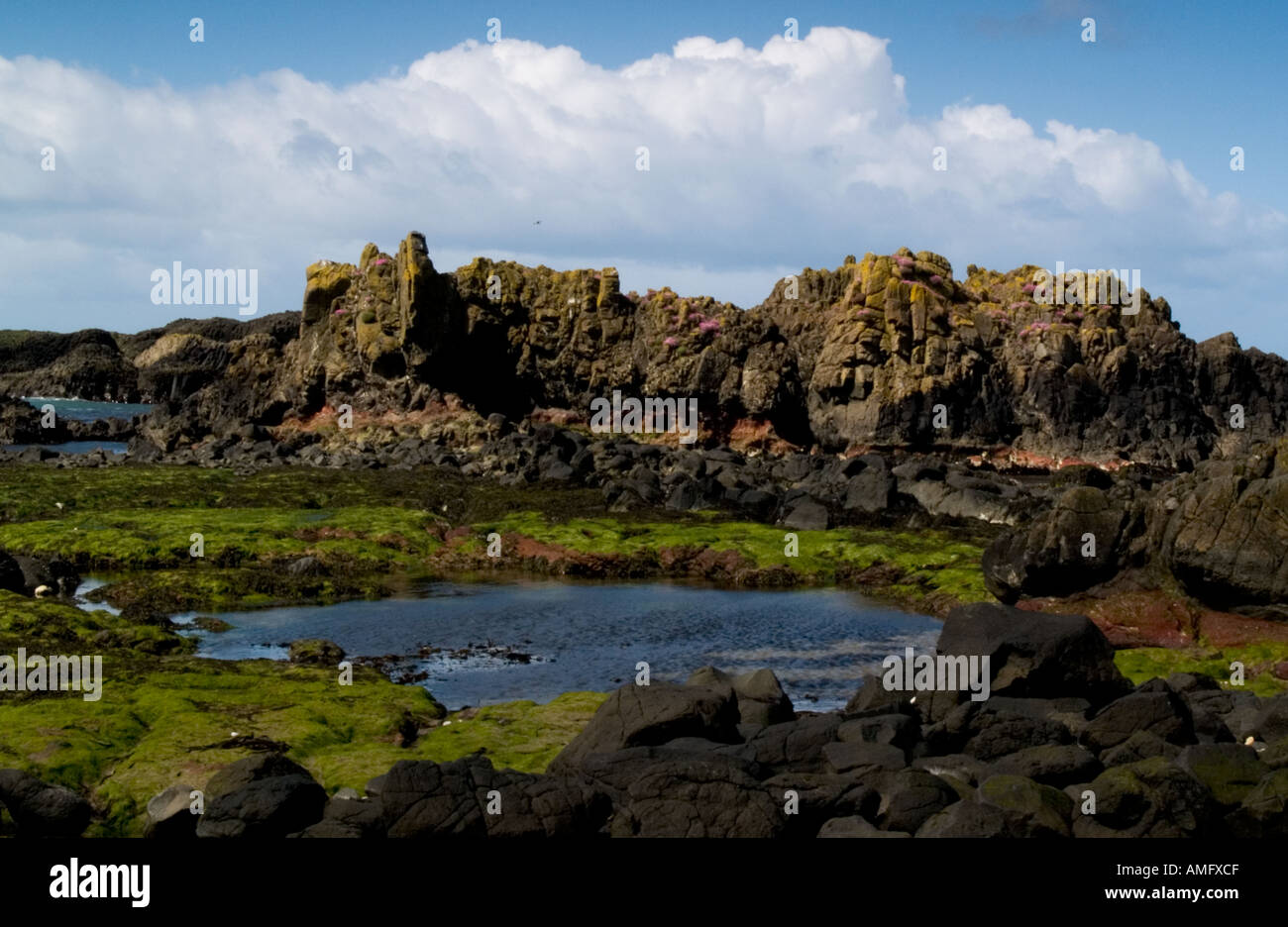 the calm waters and unusual rock formations of Ballintoy Harbour ...