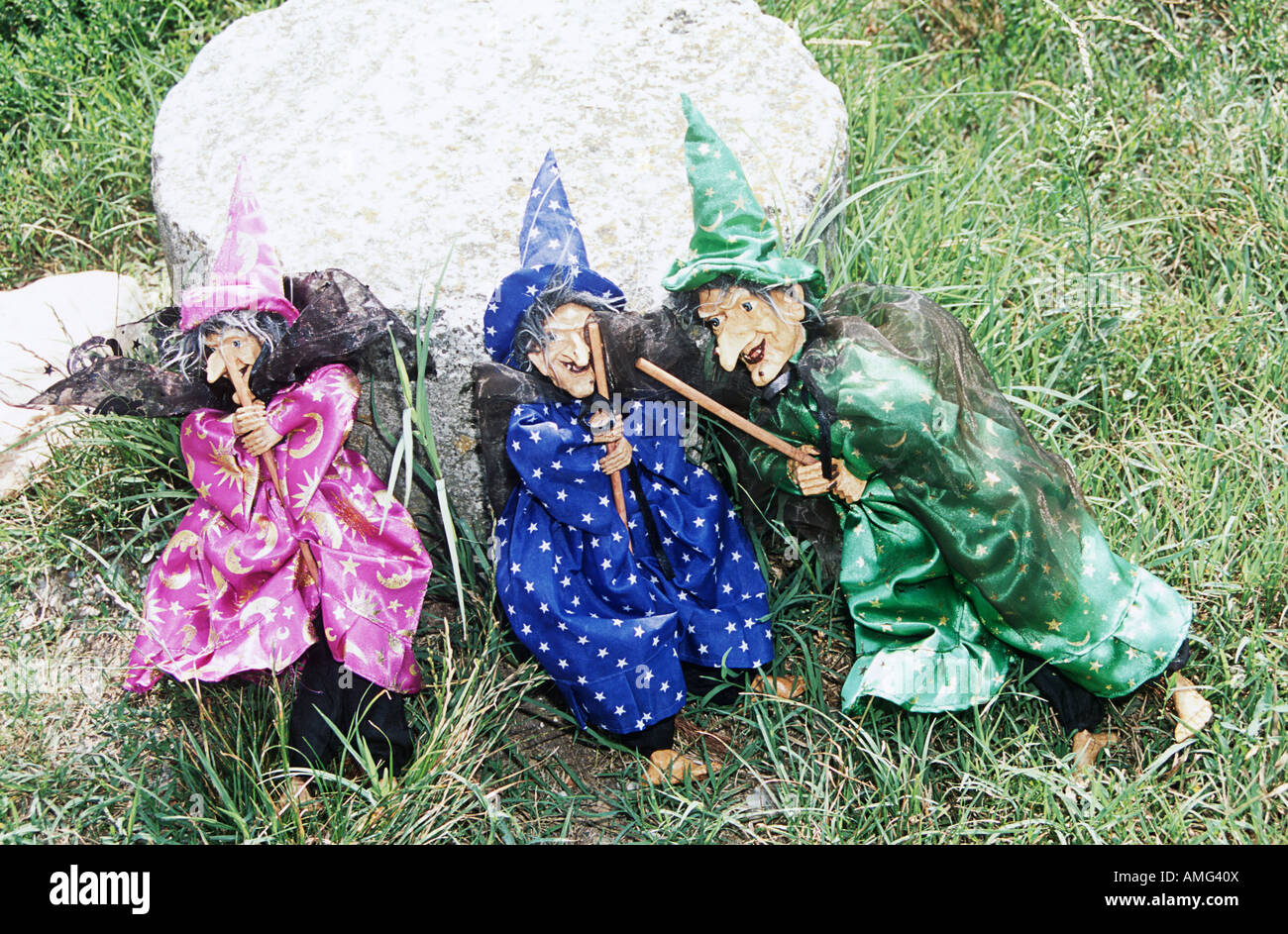 Three colourful witches for sale on display in the grass, Torcello ...