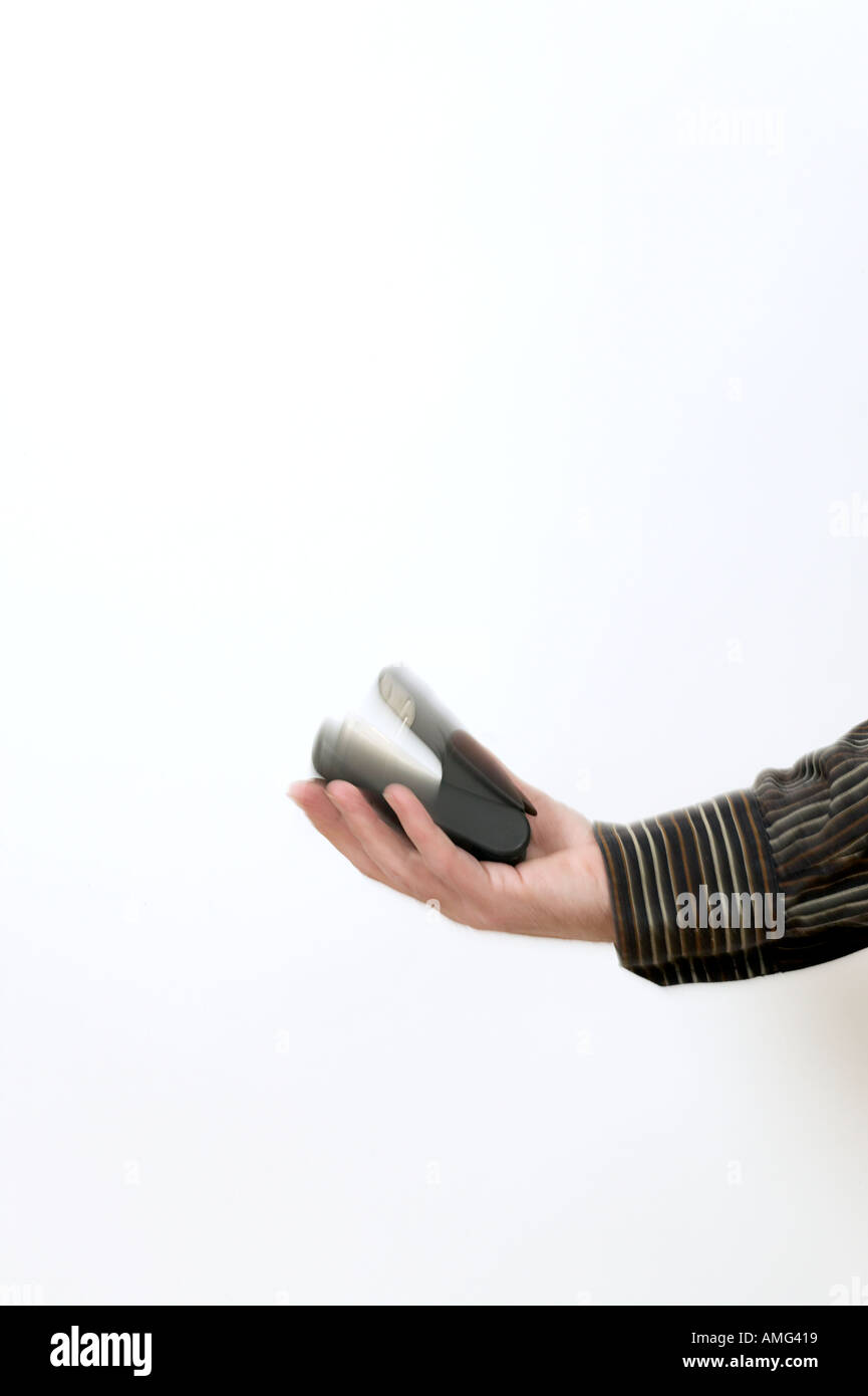 Mans hand catching falling office stapler Stock Photo - Alamy