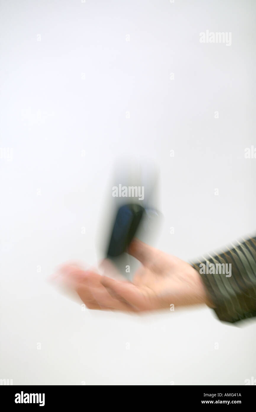 Mans hand catching falling office stapler Stock Photo - Alamy