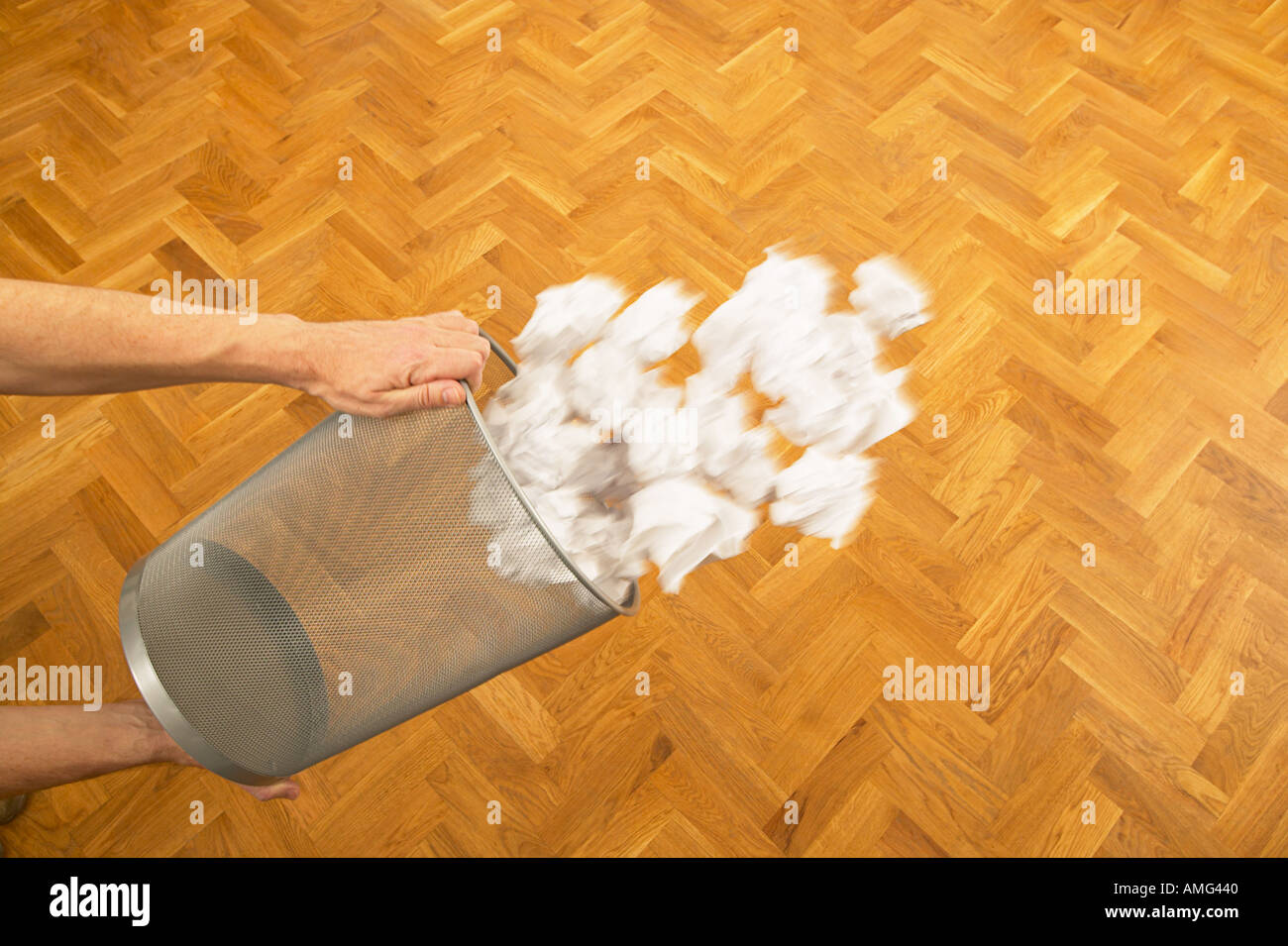 frustrated man throwing basket of waste paper across office in anger ...