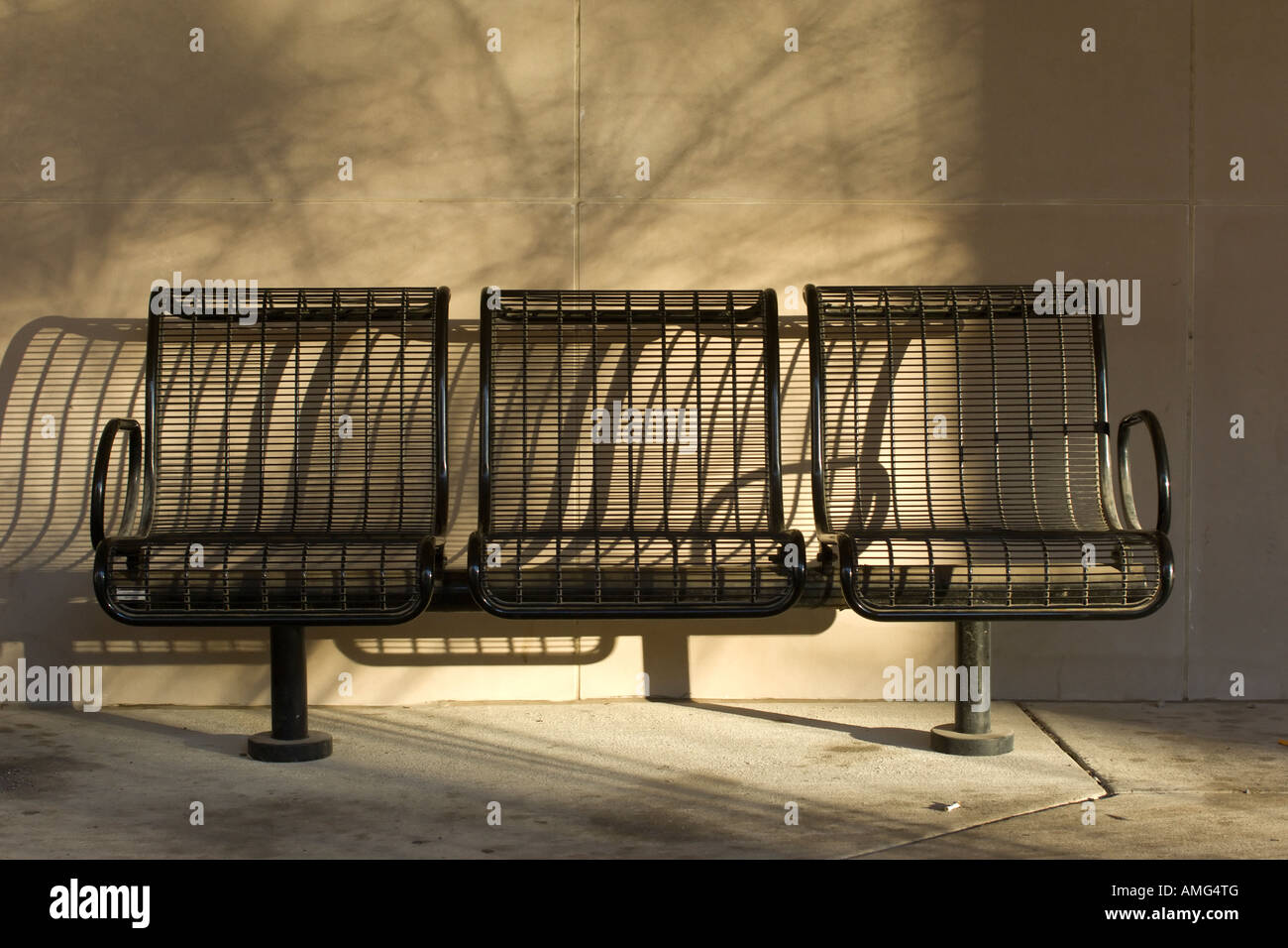 Outdoor bench with shadows from a tree Stock Photo - Alamy