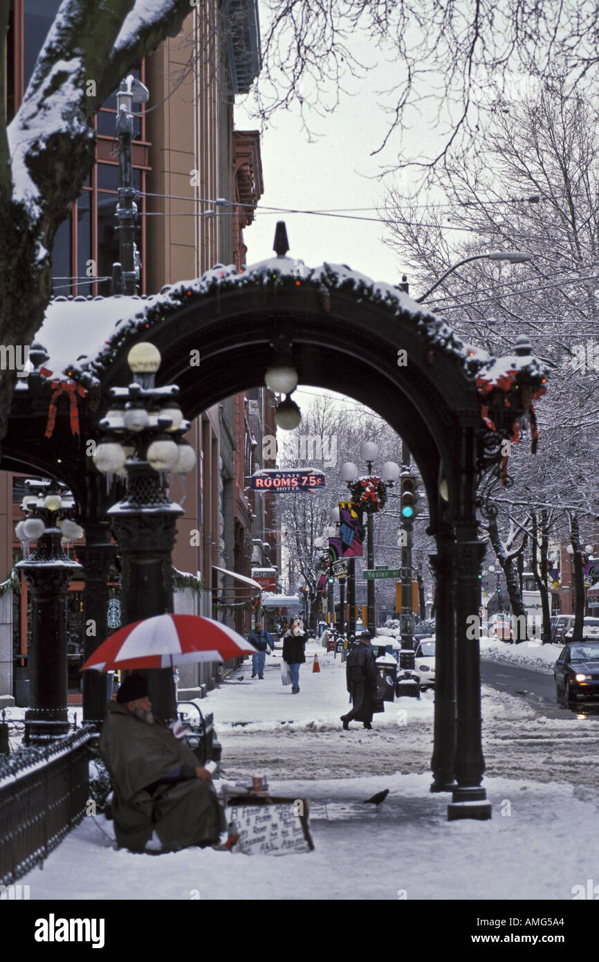 Winter Snow In Pioneer Square Where Homeless Man Sits With Umbrella ...