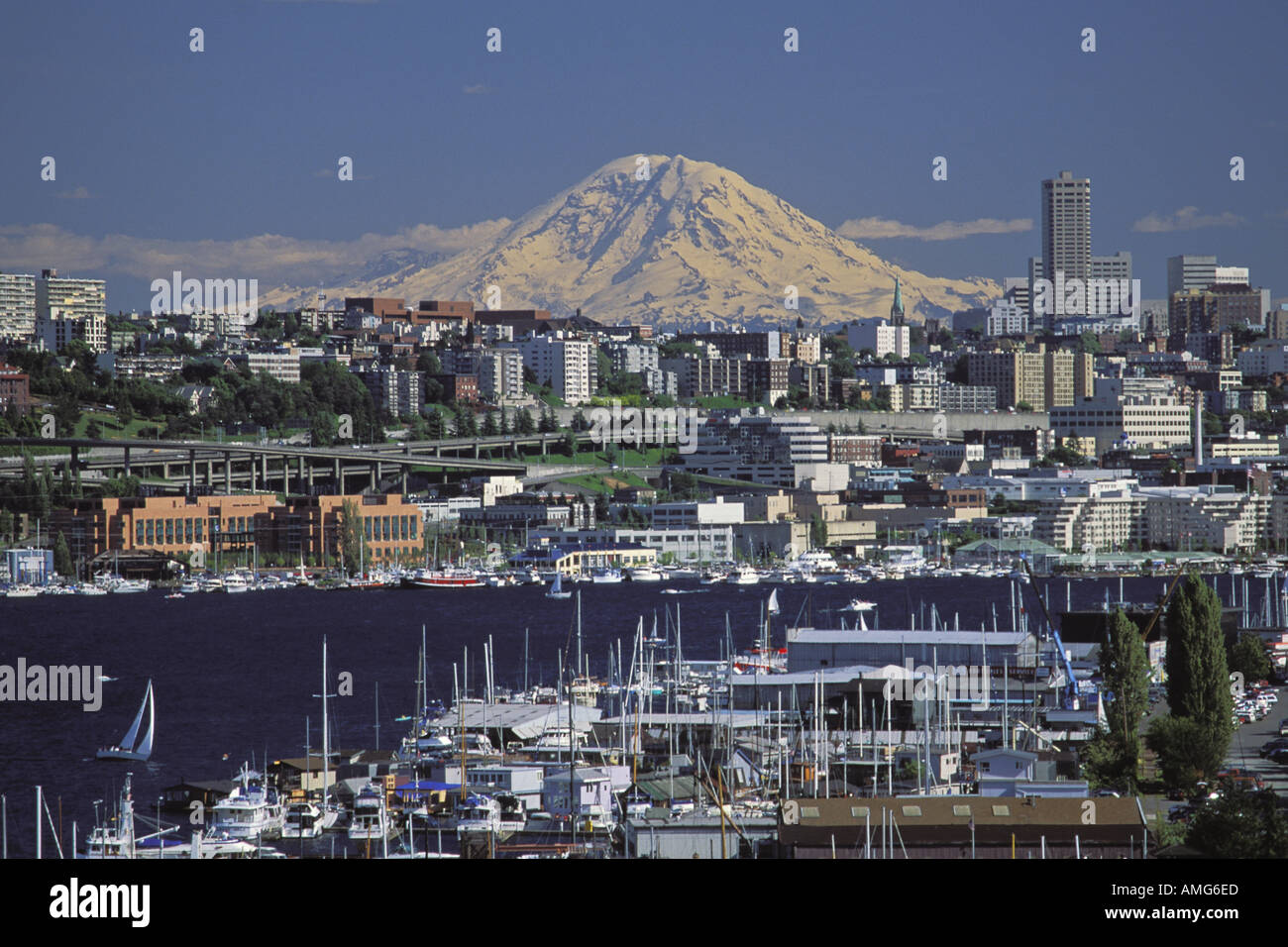Inner city Lake Union Interstate 5 freeway and snow capped Mount Rainer ...