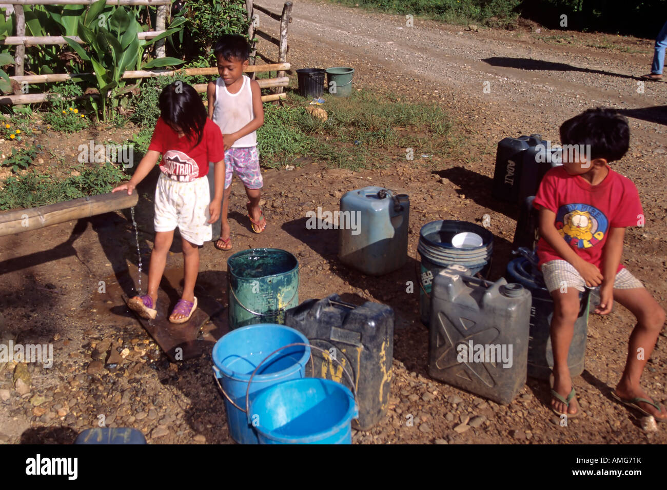 Children collecting drinking water, Boracay, Philippines Stock Photo ...