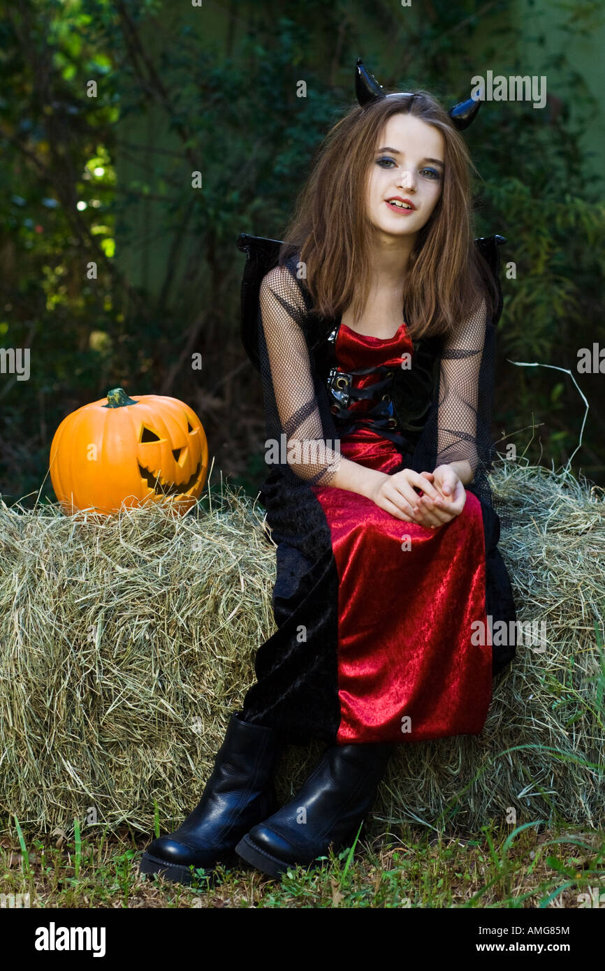 Pre-teen girl in Vampiress costume with pumpkin Stock Photo - Alamy