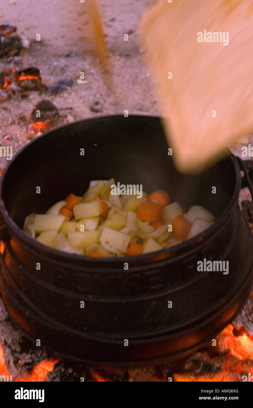 Cooking on an open fire a small caldron on an outdoor wood fire hand ...