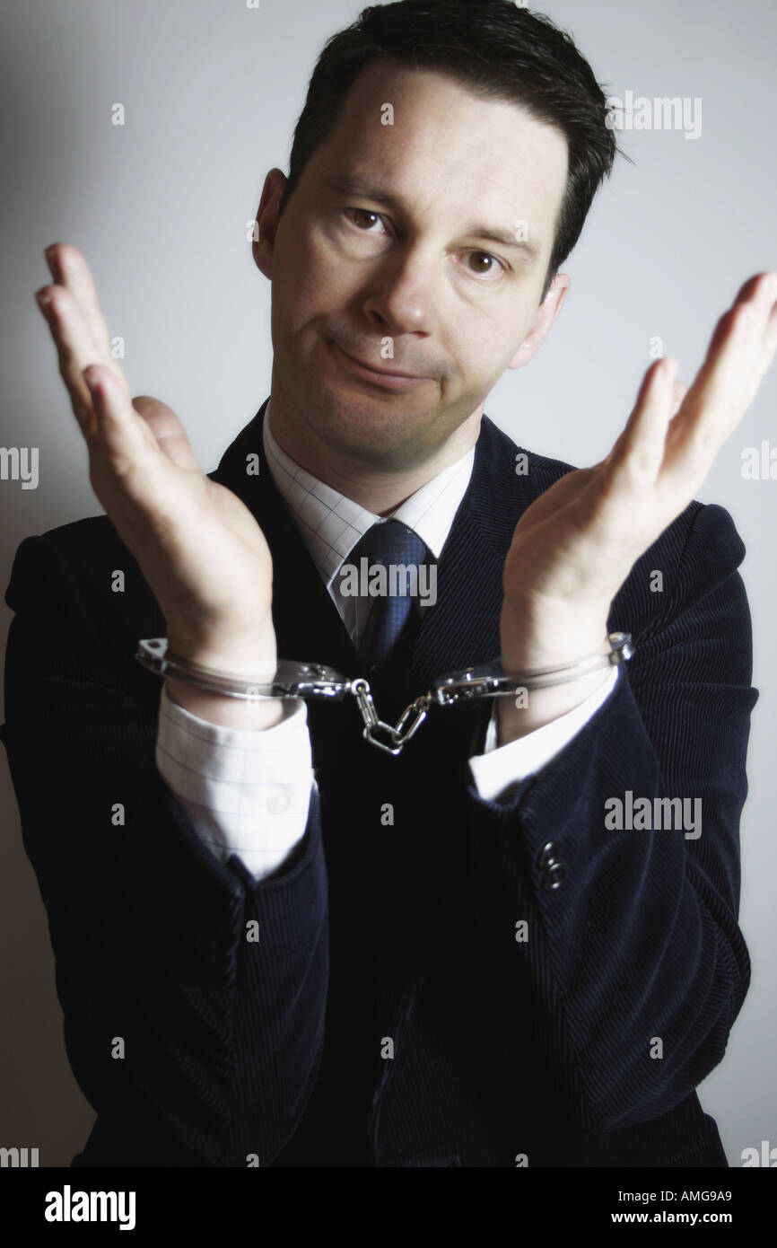 Business Man looking sulky with his hands chained Stock Photo - Alamy