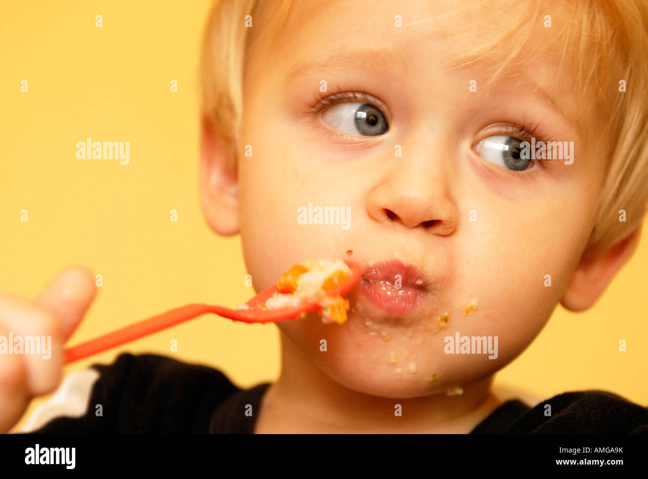 Baby boy eating Stock Photo - Alamy