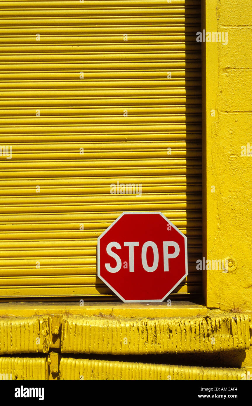Stop sign against warehouse door Stock Photo - Alamy