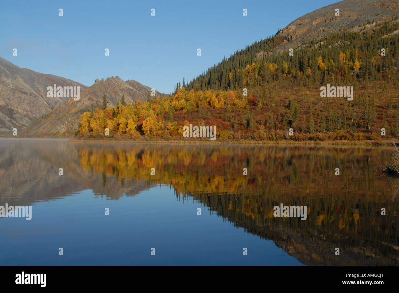 Fall colours reflecting in Summit lake, Yukon, Canada Stock Photo - Alamy