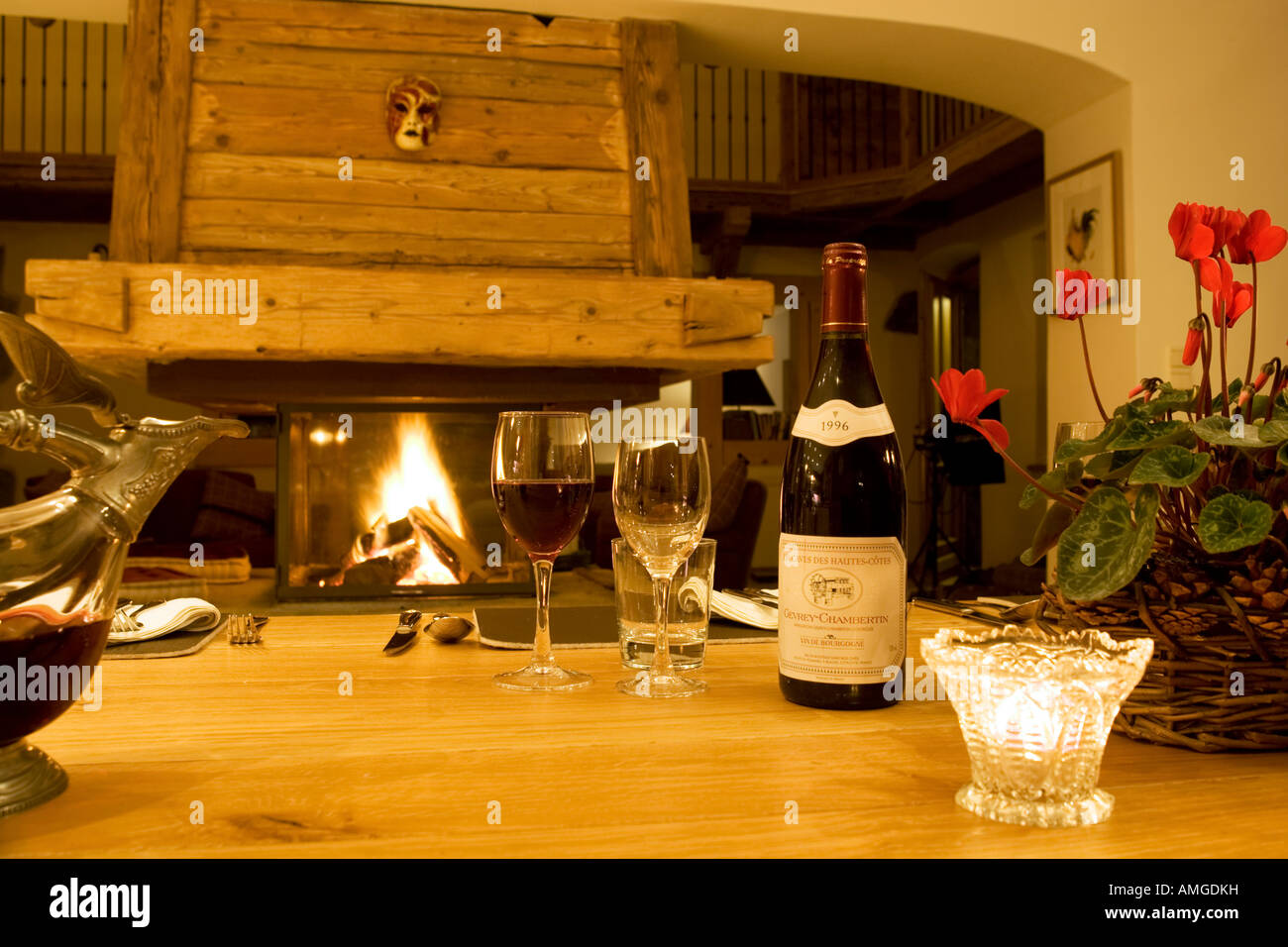 Dining room table wine and log fire Stock Photo - Alamy