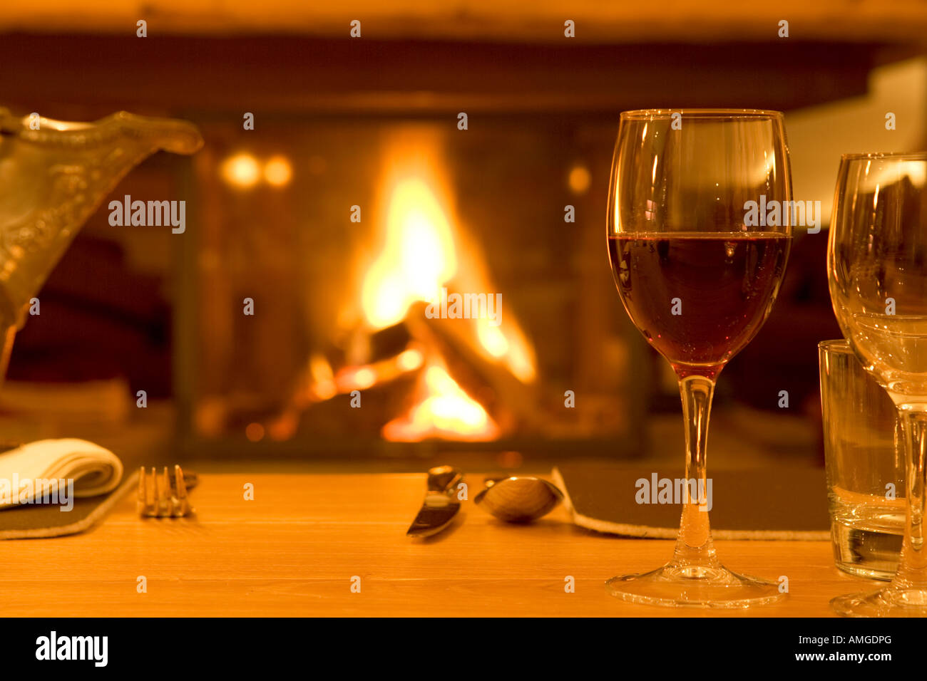 Dining room table wine and log fire Stock Photo - Alamy