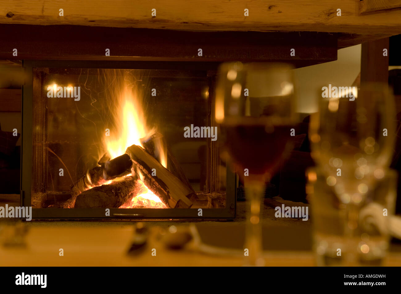Dining room table wine and log fire Stock Photo - Alamy