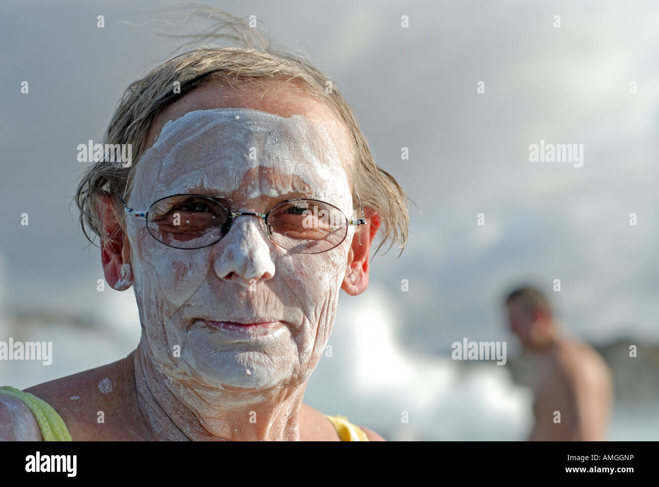 Elderly woman with skin healing mud on her face Blue Lagoon Iceland ...