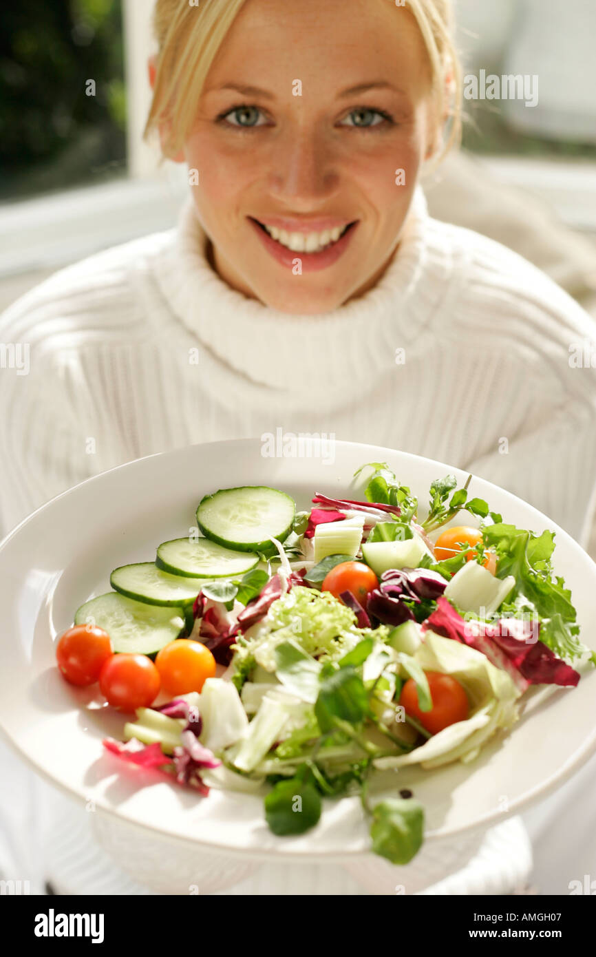 Girl eating salad Stock Photo - Alamy
