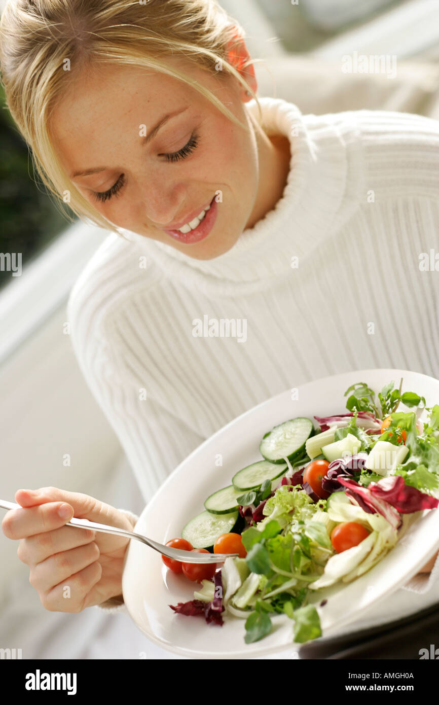 Girl eating salad Stock Photo - Alamy