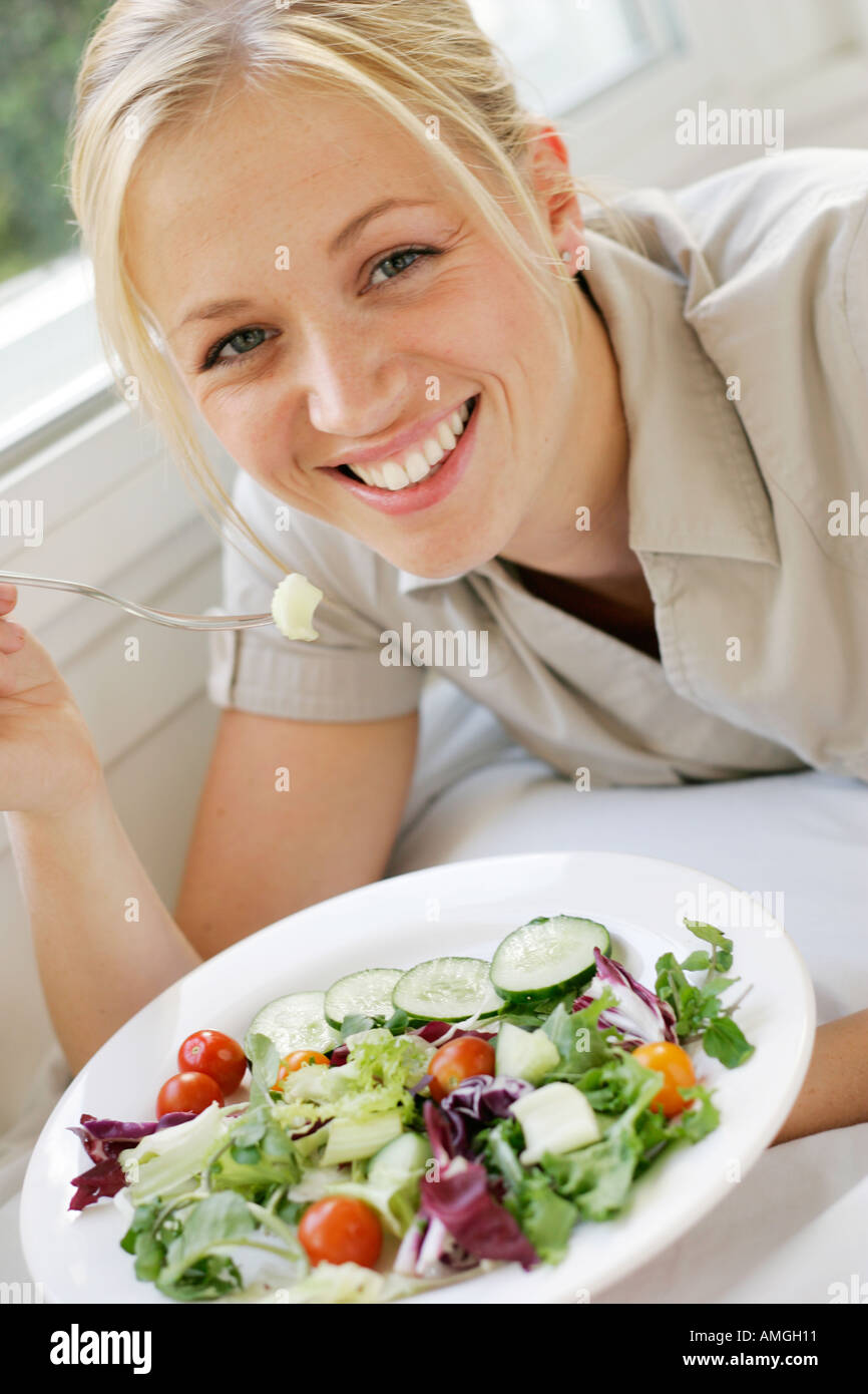 Girl eating salad Stock Photo - Alamy