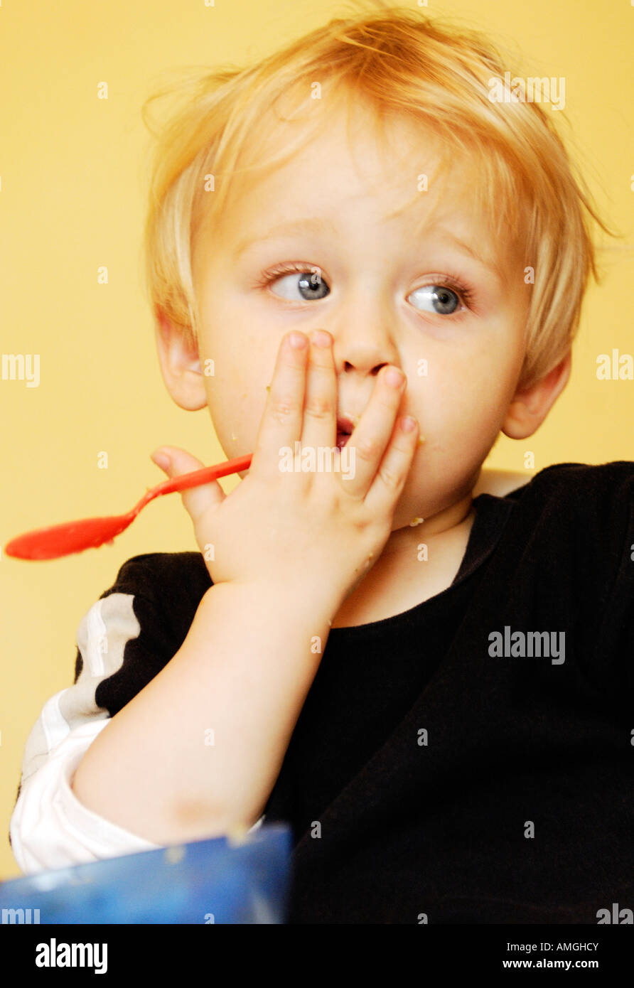 Baby boy eating Stock Photo - Alamy