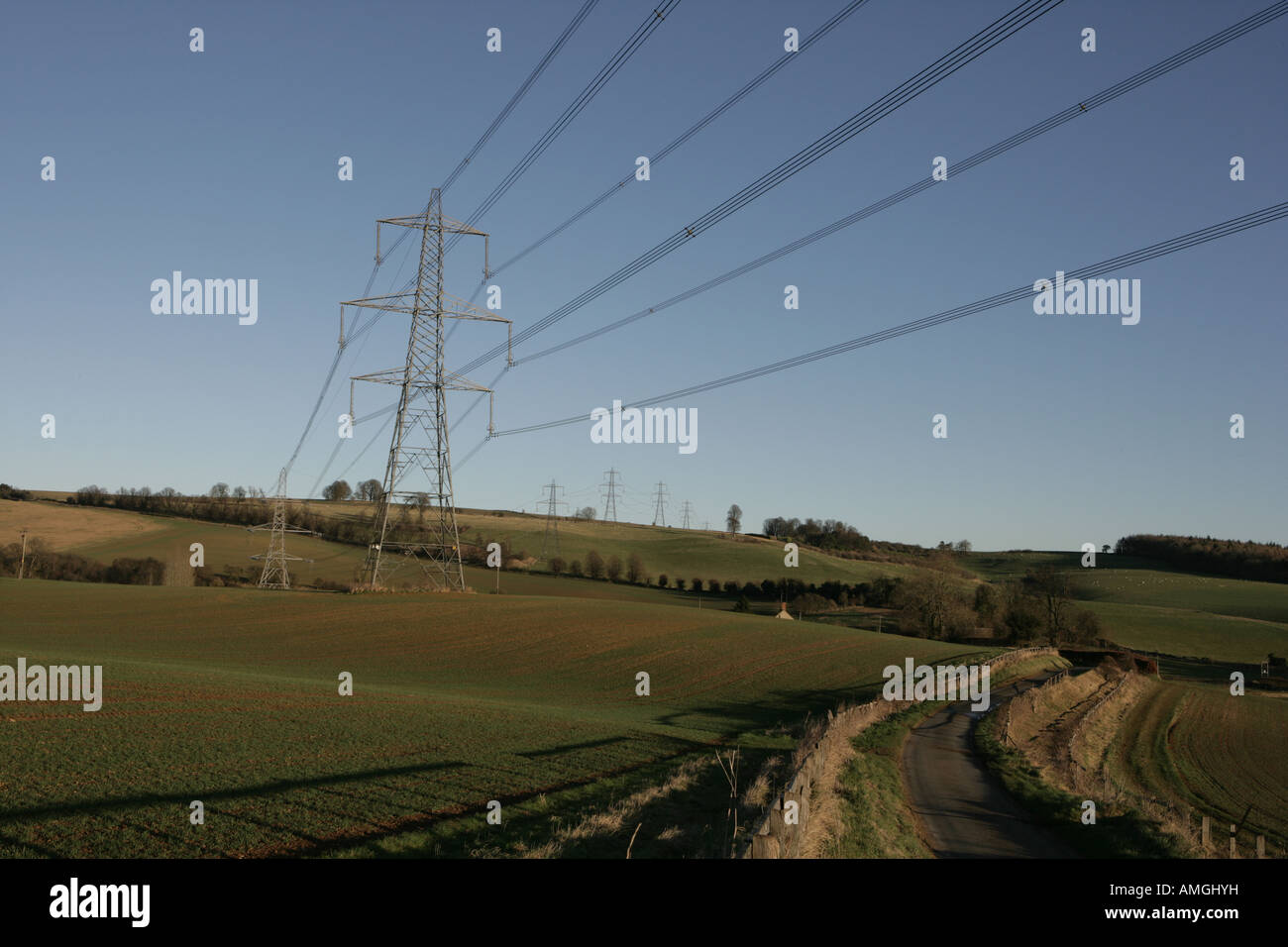 Power lines crossing a road at Cassey Compton in the cotwolds near ...