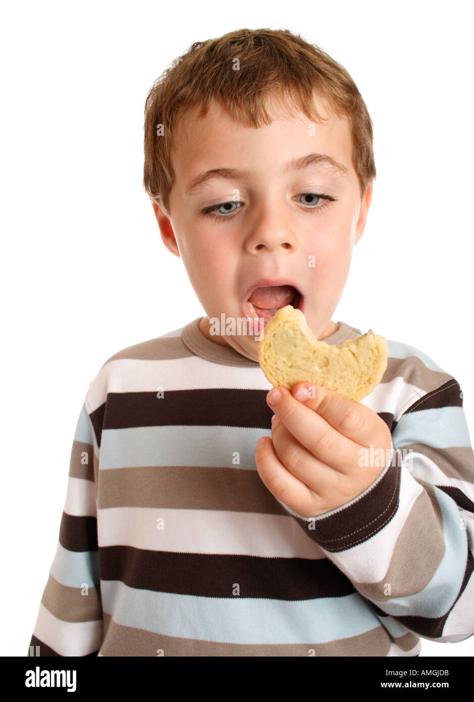 Little boy eating a biscuit Stock Photo - Alamy