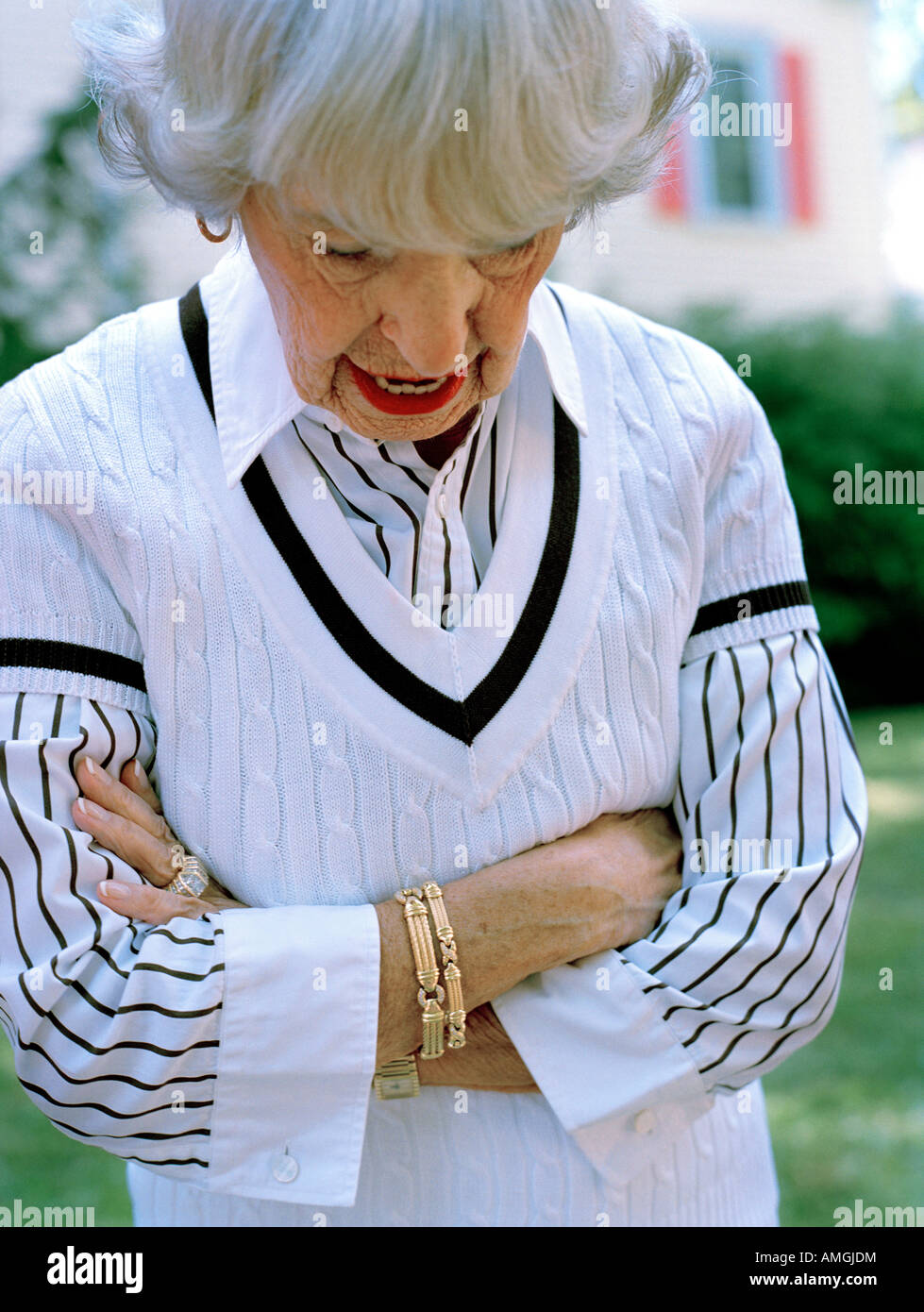 Senior woman standing outside smiling and laughing Stock Photo - Alamy