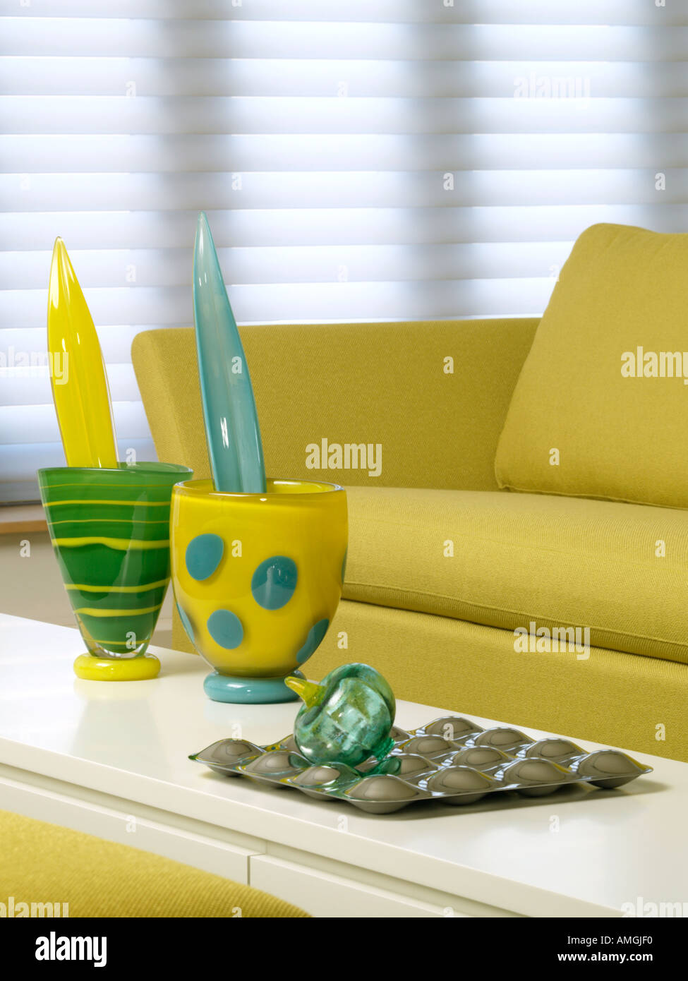 Glass art objects in color coordinated living room Stock Photo - Alamy