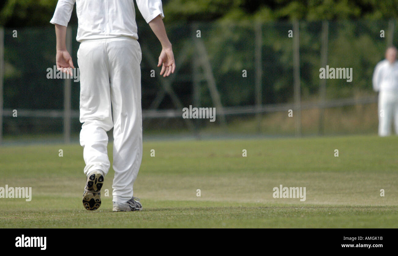 Fielders legs and back in white cricketing trousers Stock Photo - Alamy
